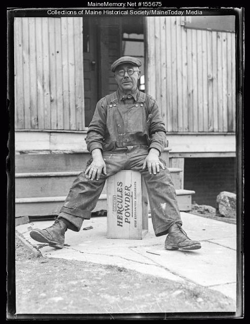"Dynamite King" John A. Whitney posing on an explosives crate, Falmouth ...