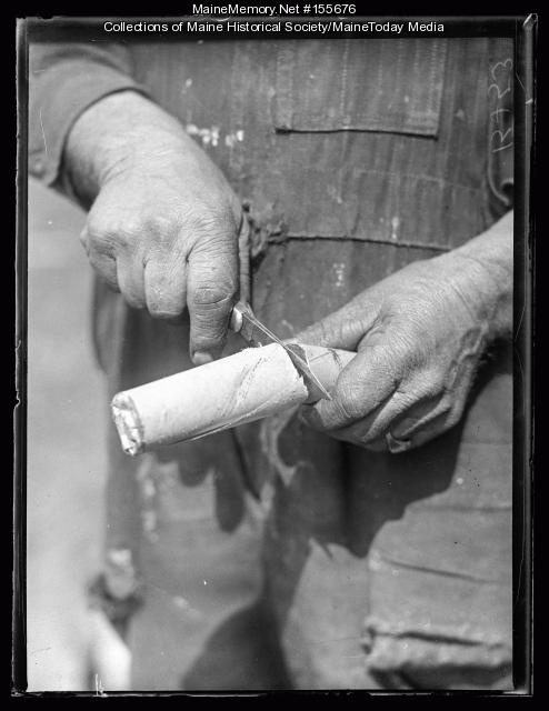 Explosives expert John A. Whitney opening a stick of dynamite, Falmouth ...