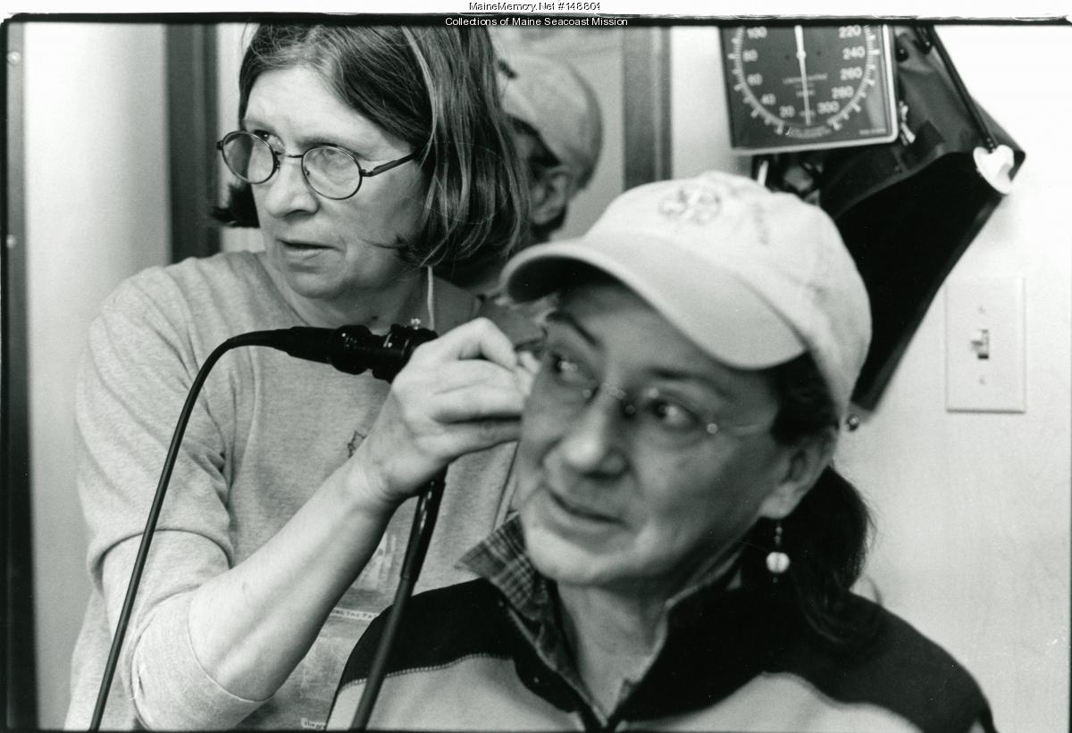 Sharon Daley Nurse performing an ear check, Matinicus Island, 2003 ...