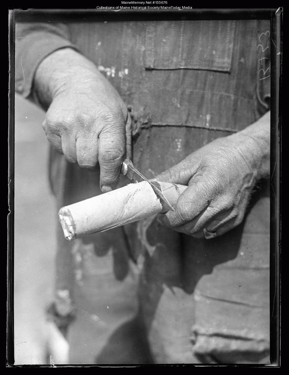 Explosives expert John A. Whitney opening a stick of dynamite, Falmouth ...